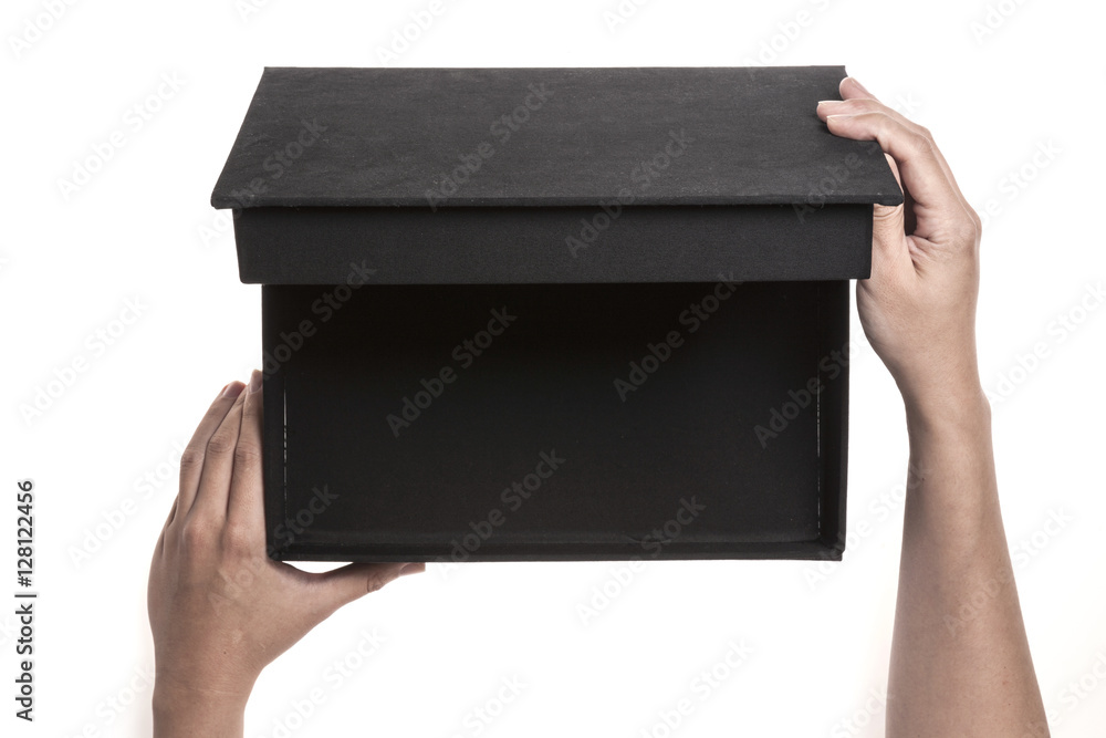 Two hands hold a empty(blank) black gift box and open isolated white ...