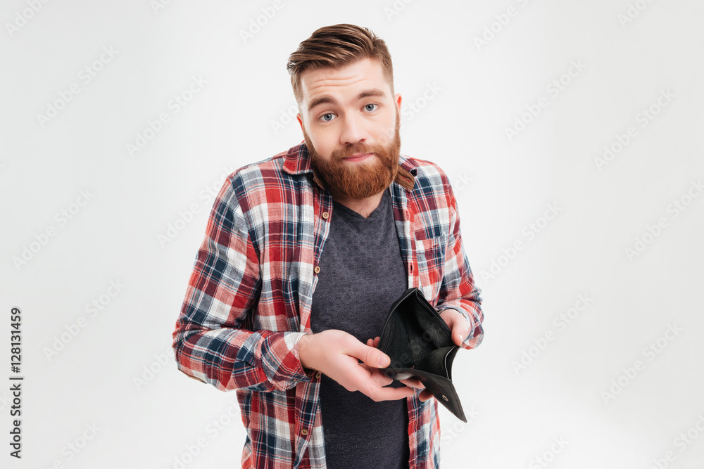 Upset young man holding empty wallet Stock Photo | Adobe Stock