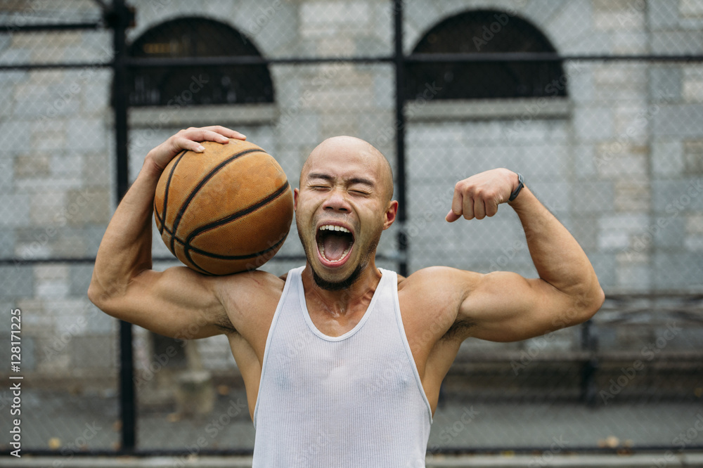 Happy basketball player screaming on court Stock Photo | Adobe Stock