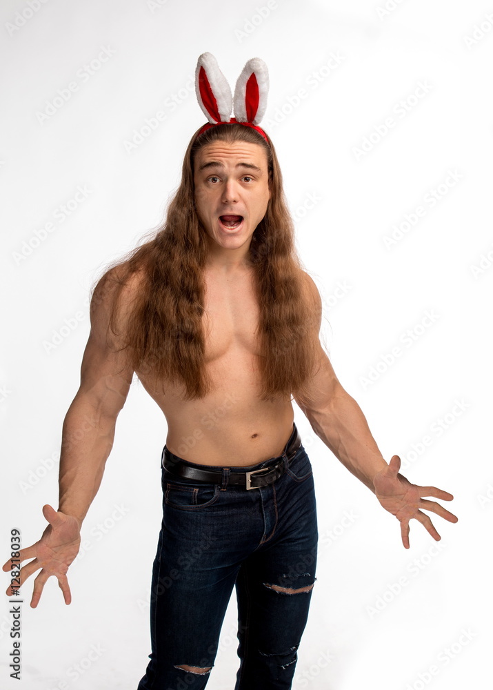 athlete bodybuilder shirtless with long hair posing with a rabbit-like ...