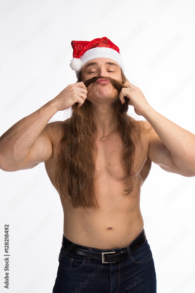 athlete bodybuilder shirtless with long hair posing in cap Santa Claus ...