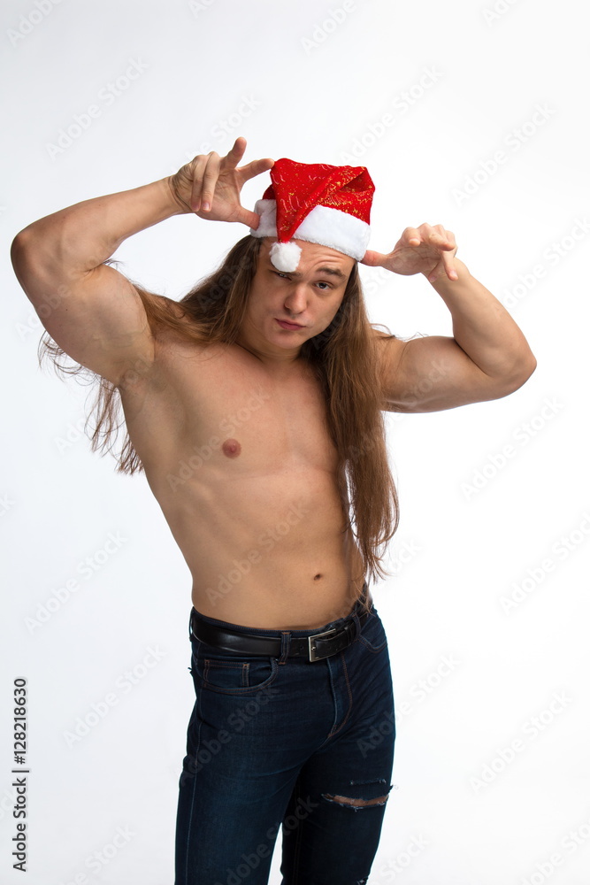 athlete bodybuilder shirtless with long hair posing in cap Santa Claus ...