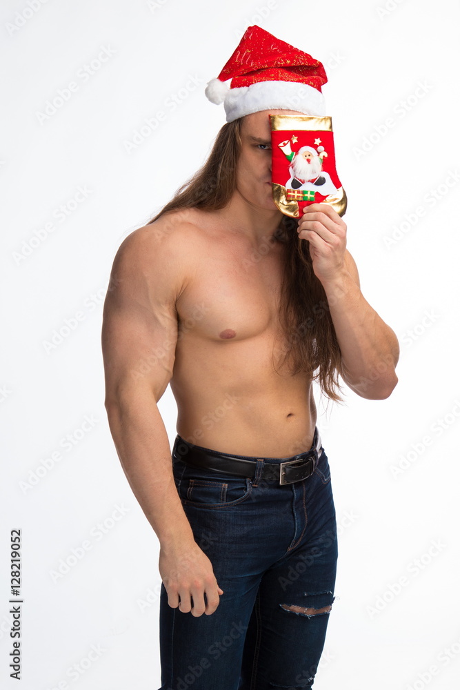 athlete bodybuilder shirtless with long hair posing in cap Santa Claus ...