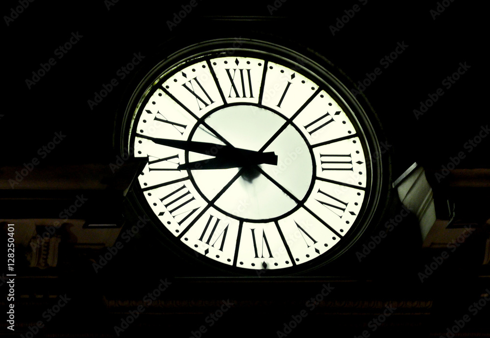 Vintage outdoor lighted clock, roman figures, night time Stock Photo ...