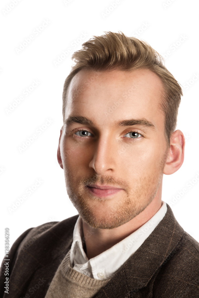 A attractive man in his 20s standing against a white background wearing ...