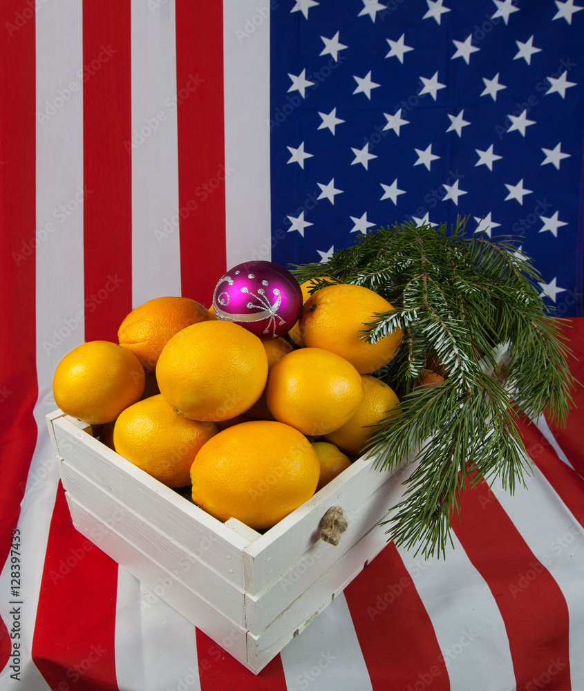 Christmas oranges in the white box on the background of the USA flag ...