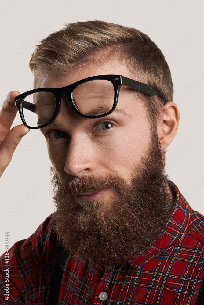 Close up portrait of handsome sceptical man with eye glasses and red ...