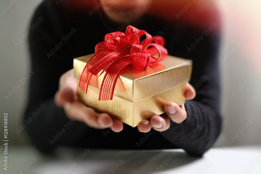 gift giving,man hand holding a gift box in a gesture of giving.b Stock ...