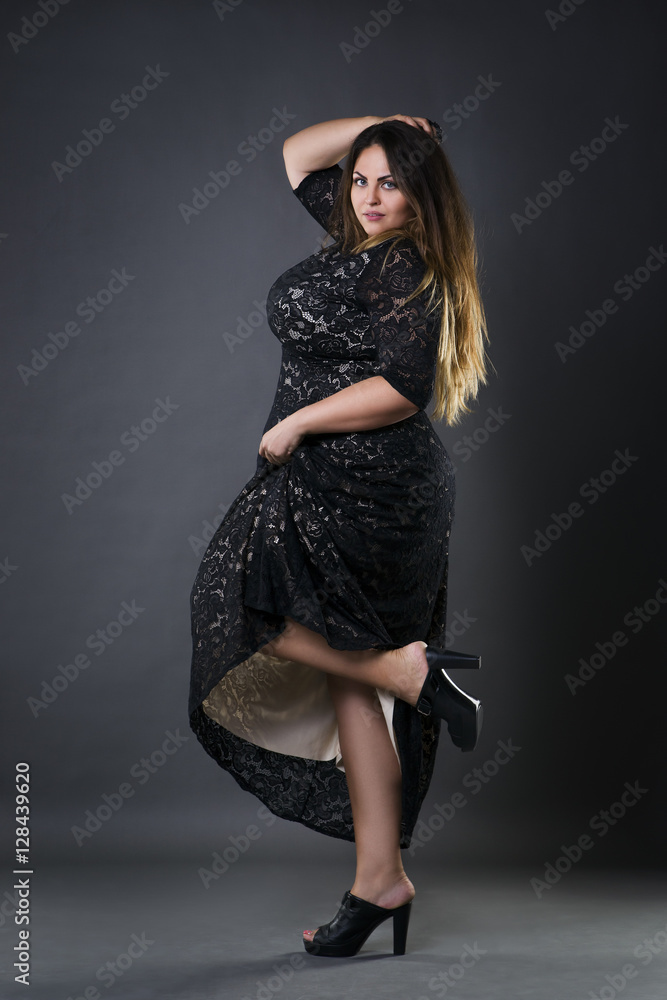 Young beautiful plus size model in black dres, xxl woman on gray studio ...