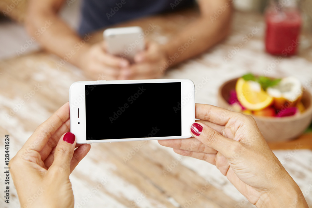 Technology and communication concept. Female hands holding smart phone ...