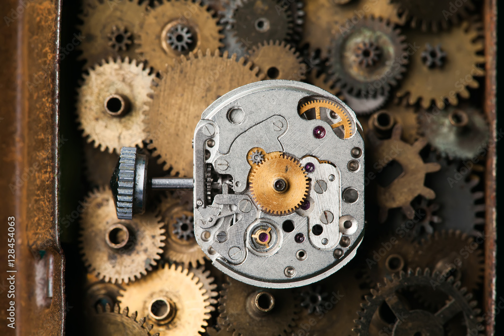 Aged mechanical clock macro view, rusty metal gears background. Shallow ...