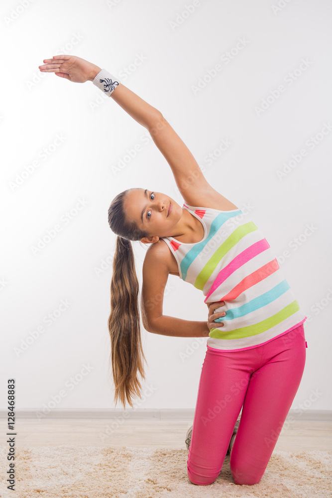 Beautiful woman doing fitness exercises slopes. Beautiful teen girl in ...