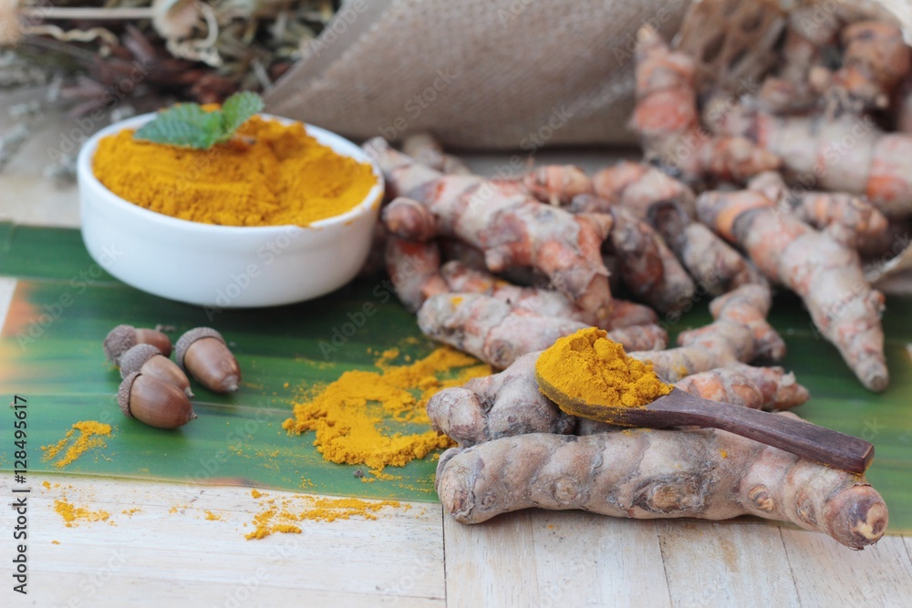 Turmeric powder and fresh root is herb. Stock Photo | Adobe Stock