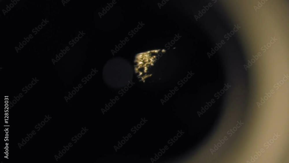 Hand held shot through the telescope of a moon surface with craters ...