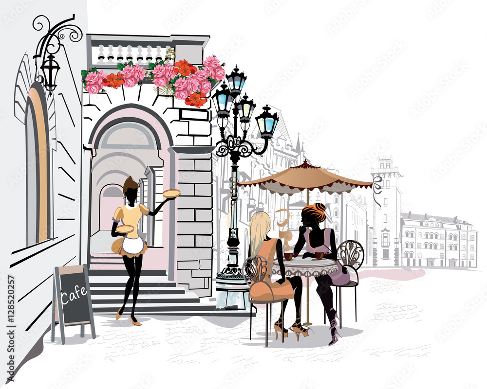 Fashion girls in the street cafe. Street cafe with flowers in the old ...
