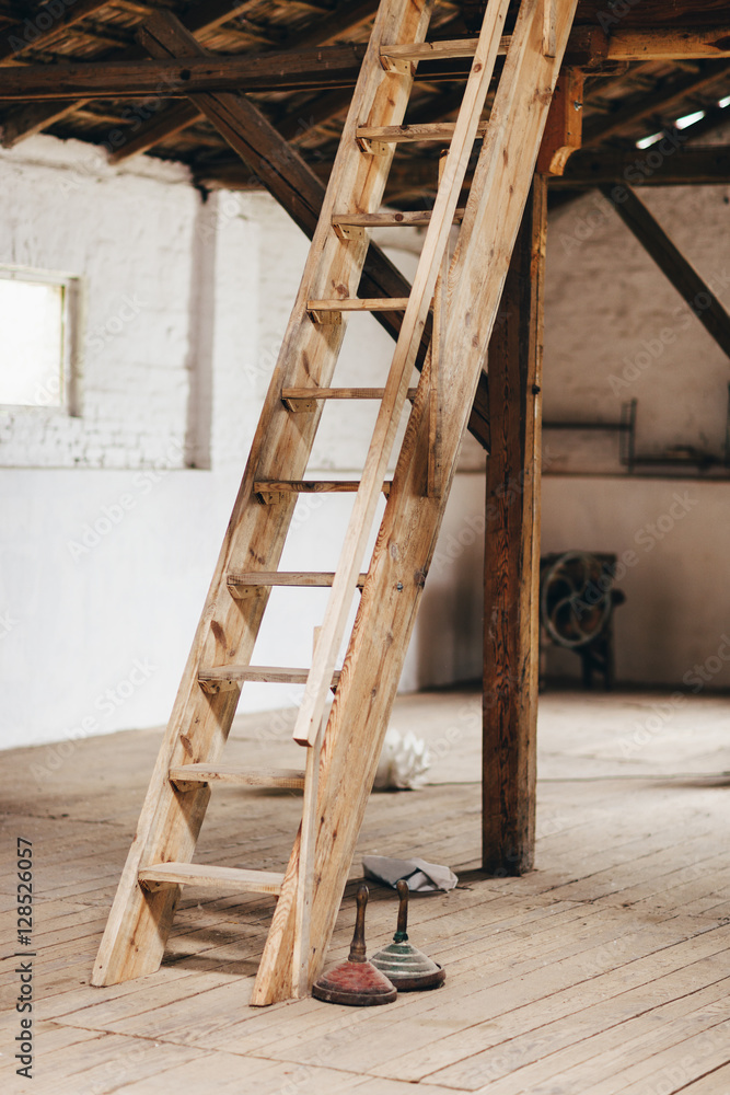 Wooden attic ladder stairs in a rustic interior. Stock Photo | Adobe Stock