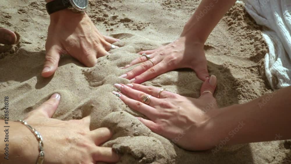 Hands forming heart. Couple hands forming heart shape on sand. People ...