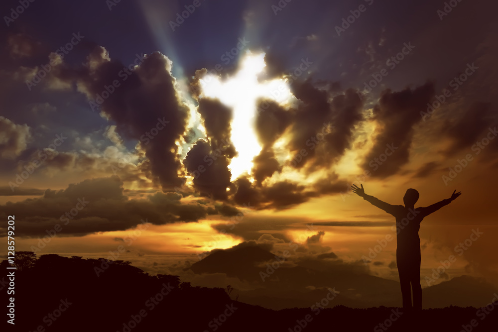 Man praying to god with ray of light shaping cross on the sky Stock ...