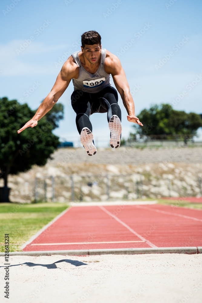 Athlete performing a long jump Stock Photo | Adobe Stock