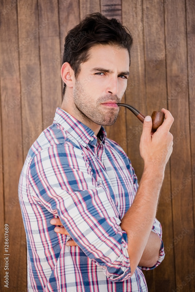 Young man smoking pipe Stock Photo | Adobe Stock