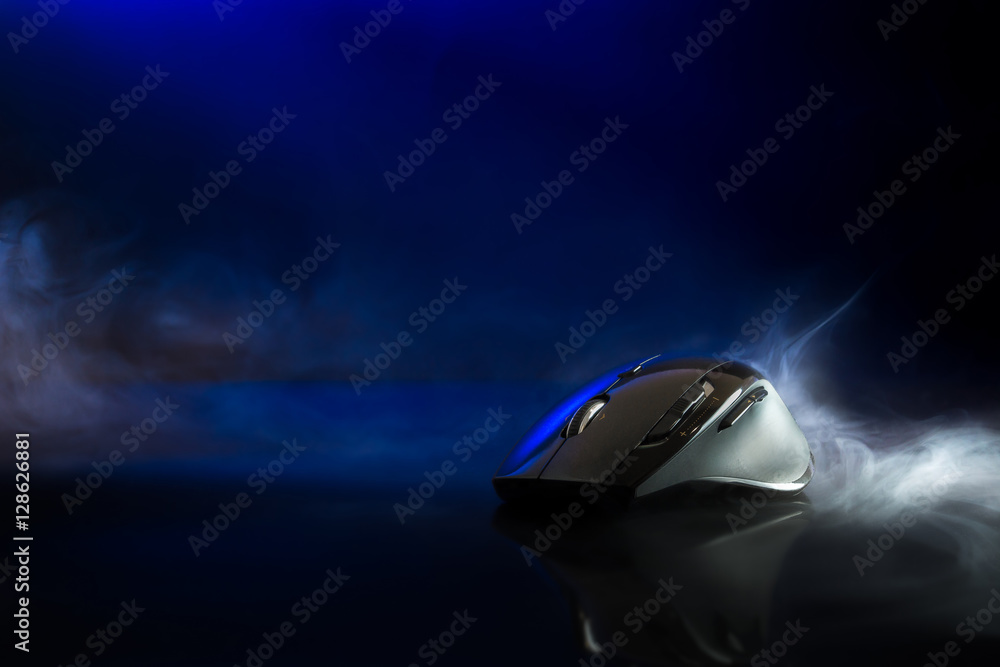 High technology computer gaming mouse in dark blue tone with smoke ...
