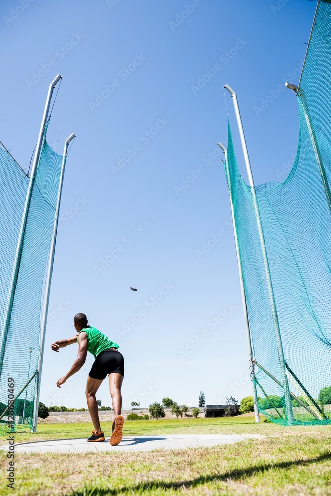 Athlete throwing discus in stadium Stock Photo | Adobe Stock