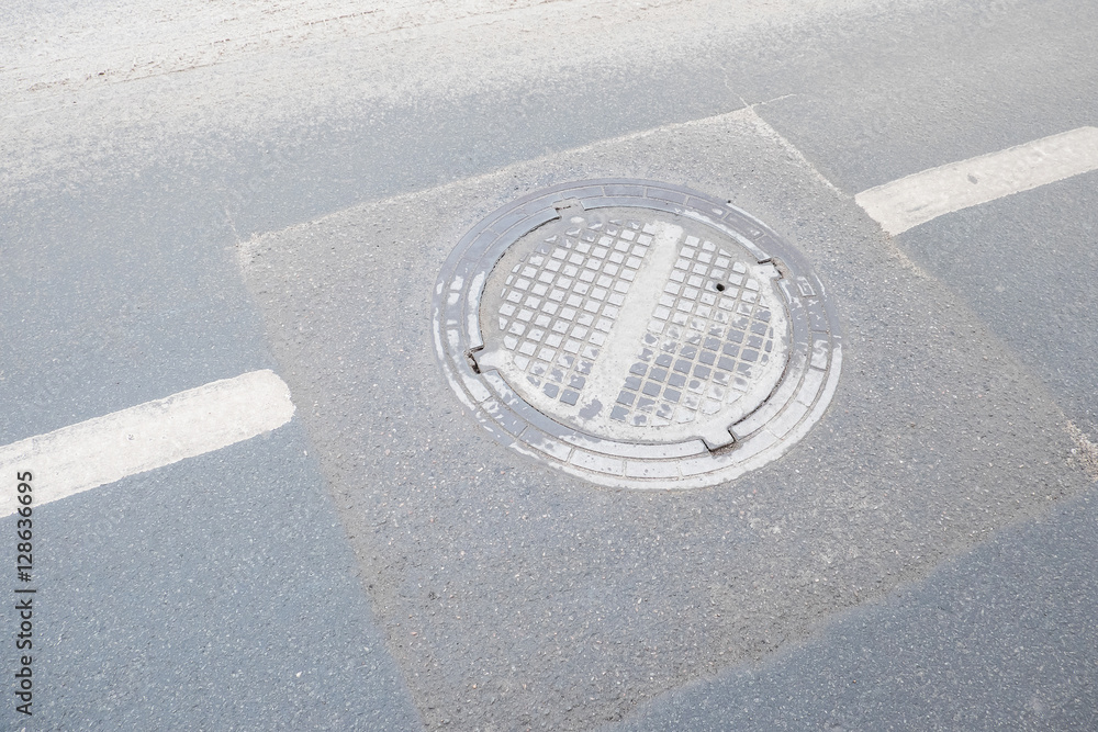 manhole cover on the road Stock Photo | Adobe Stock