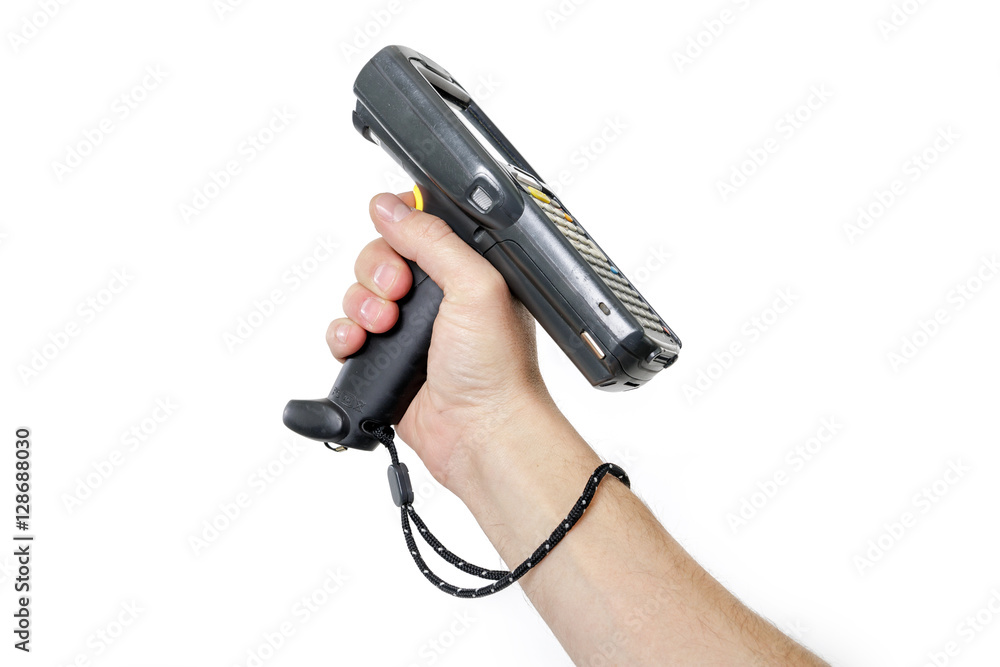 Man's hand holding a barcode scanner. The scanning device is directed ...