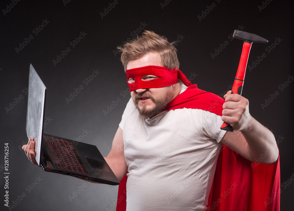 Hacker. Computer repair. Picture of super hero man posing with laptop ...