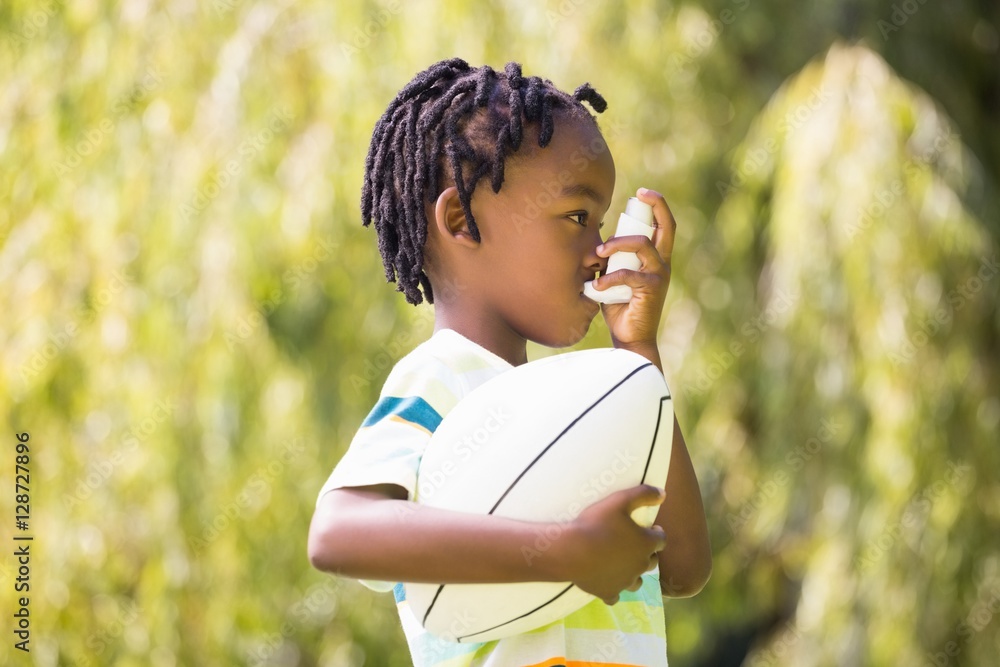 Child is using an asthma inhaler Stock Photo | Adobe Stock