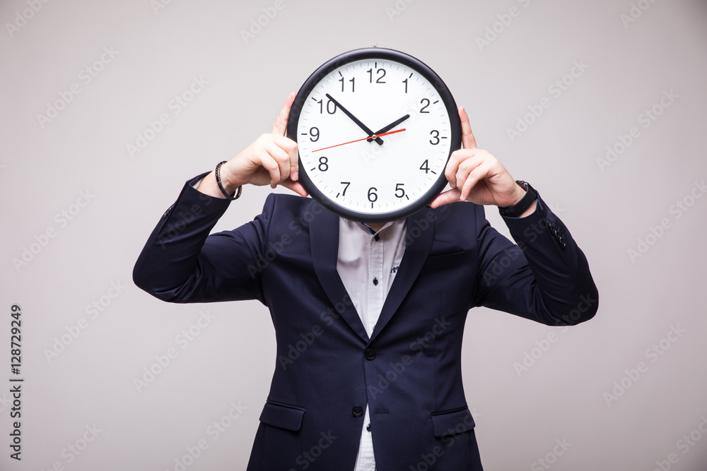 Handsome man with clock over head Stock-Foto | Adobe Stock
