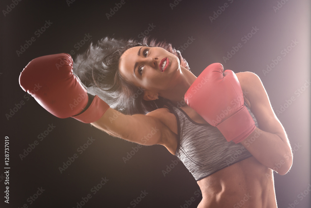 Boxing concept. Brunette woman with red lips making direct his during ...
