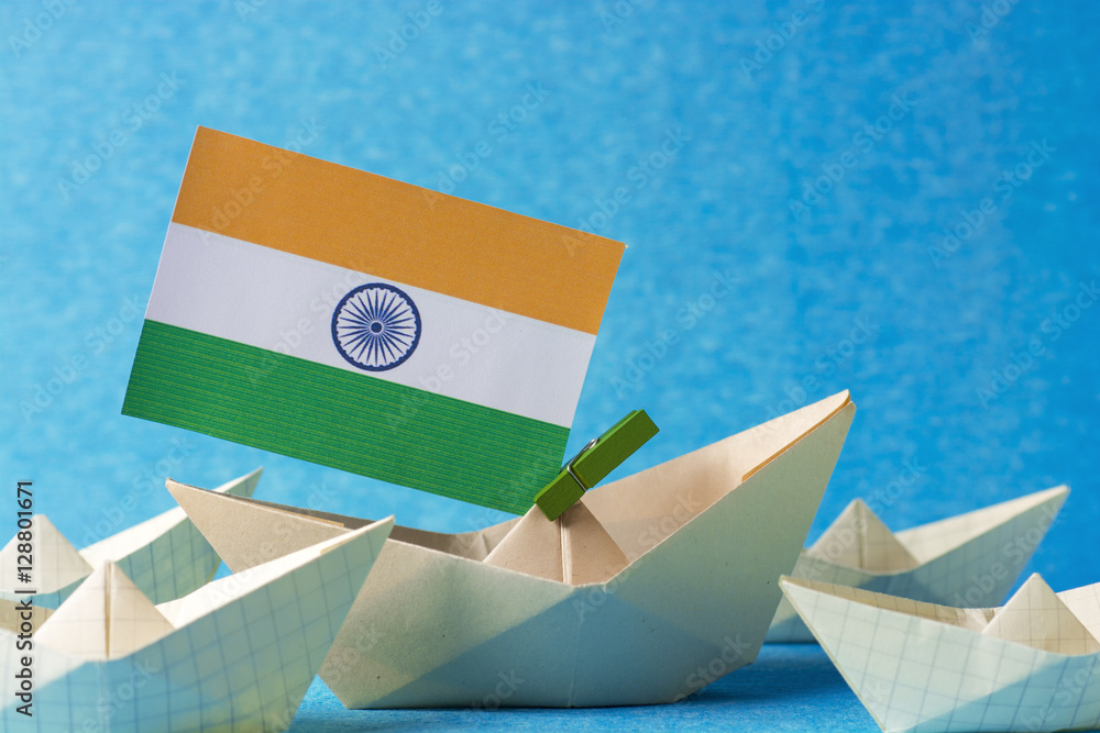 paper ship with Flags of India on turquoise blue green sea water ocean ...