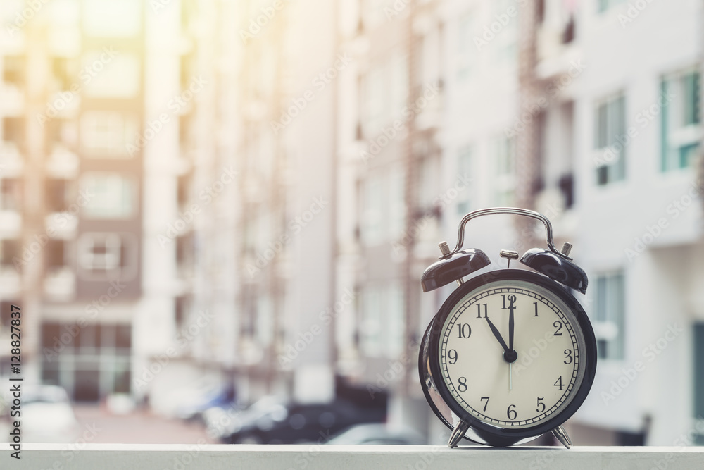 11 o'clock retro clock with The Clock condominium background. Stock ...