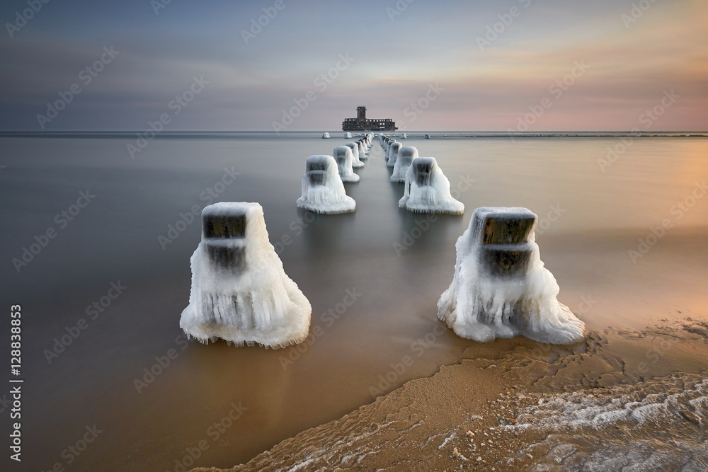 Frozen wooden breakwaters line to the world war II torpedo platform at ...