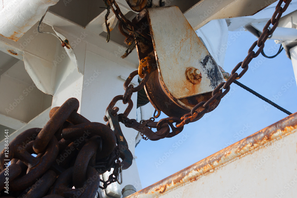Hugh metal block and tackle suspended from the structure of a large ...