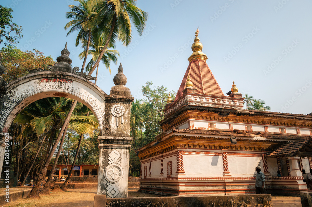 Ancient Hindu Shree Morjai Temple at Morjim amidst a coconut grove. In ...