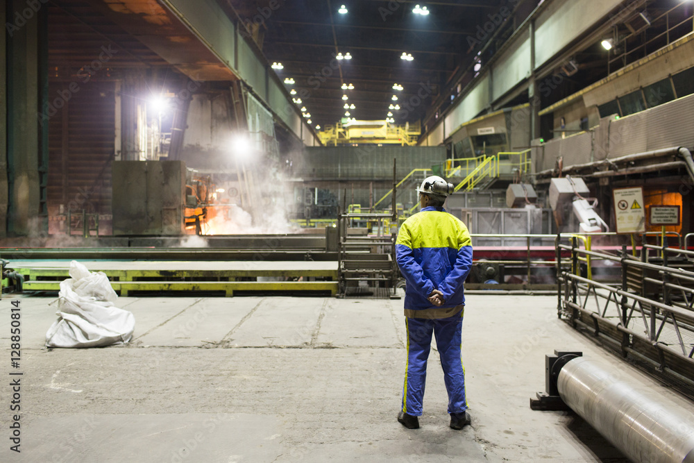 workers of a steel factory look at the manufacturing process Stock ...