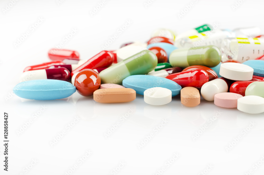 Pharmacy theme. Multicolored Isolated Pills and Capsules on the White ...