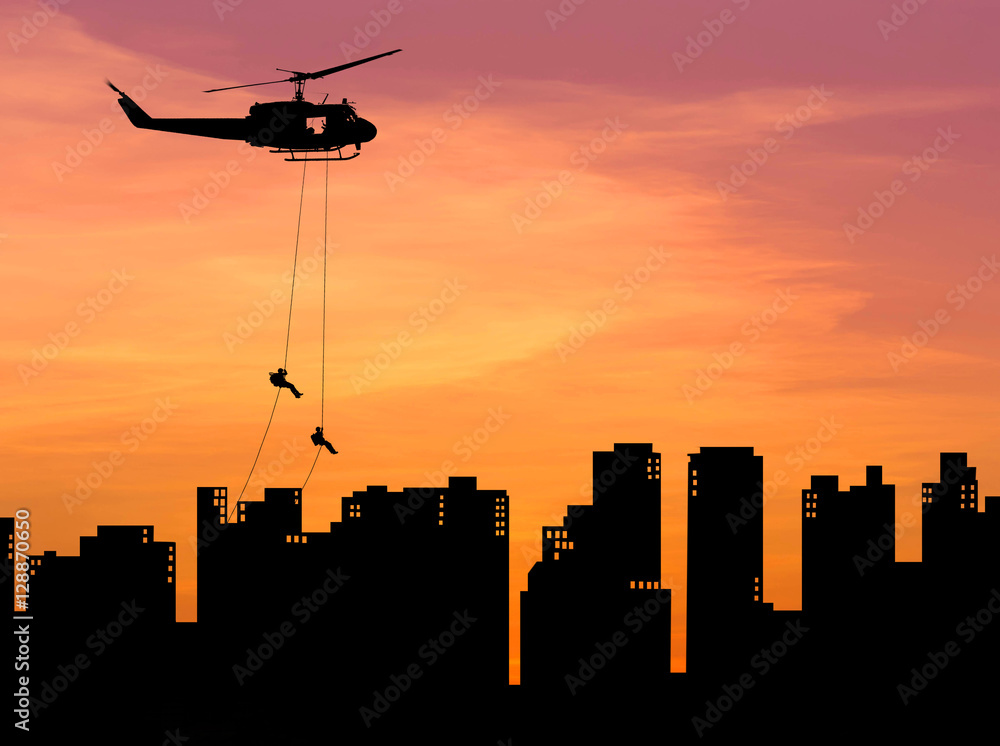 silhouette soldiers in action rappelling climb down from helicopter ...