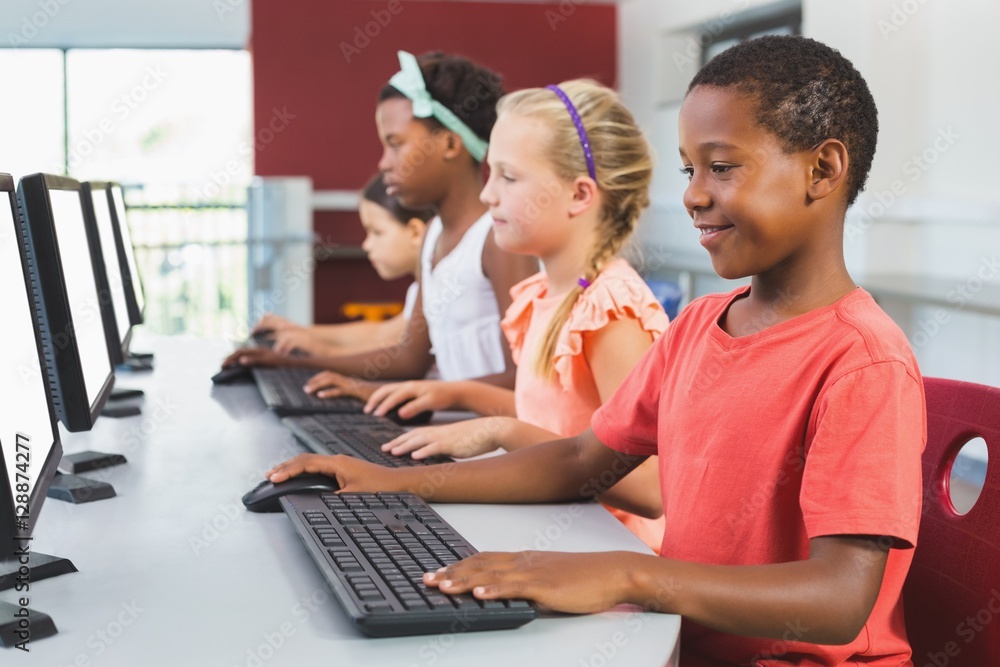 School kids using computer in classroom Stock Photo | Adobe Stock