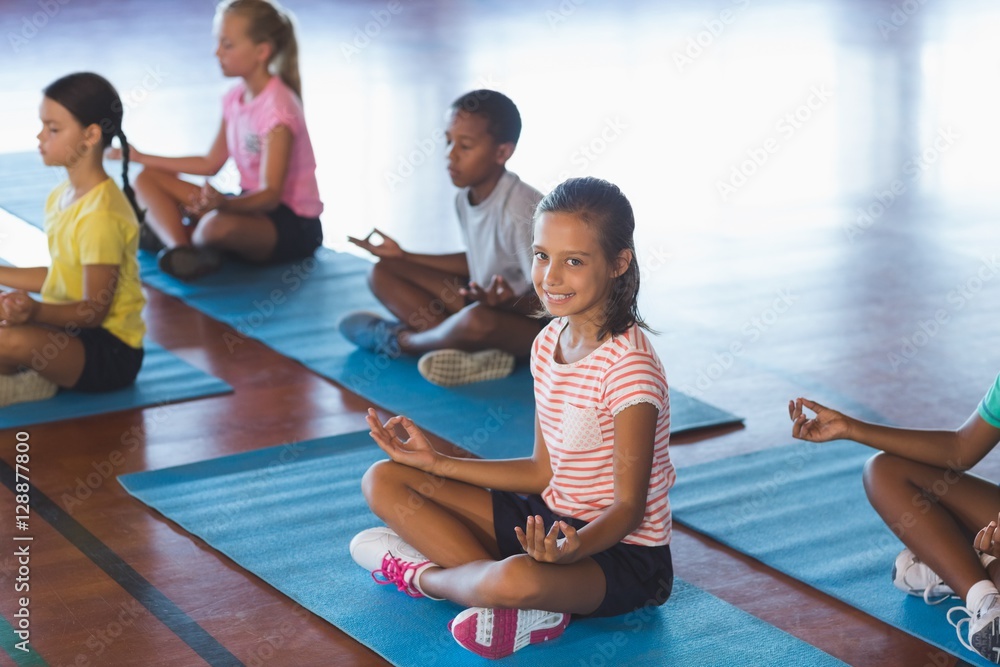 School kids meditating during yoga class Stock Photo | Adobe Stock