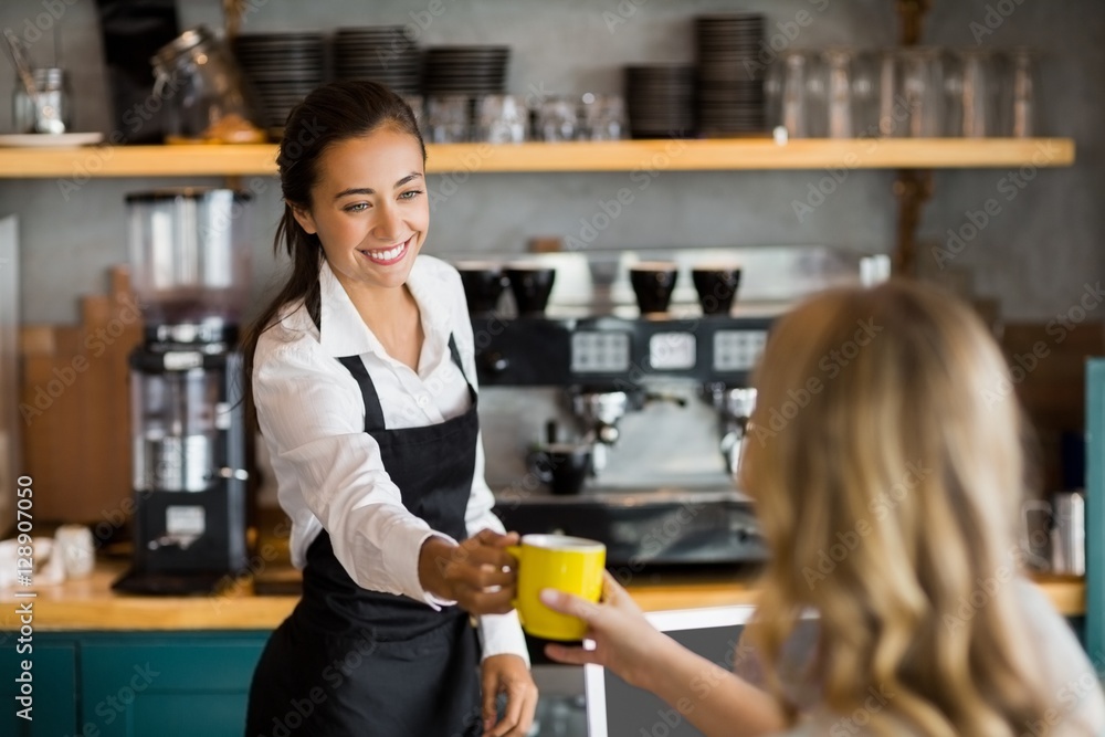 Waitress offering a cup of coffee Stock Photo | Adobe Stock