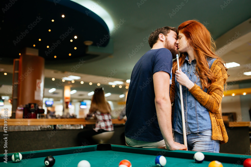 Beautiful couple kissing in billiards bar Stock Photo | Adobe Stock