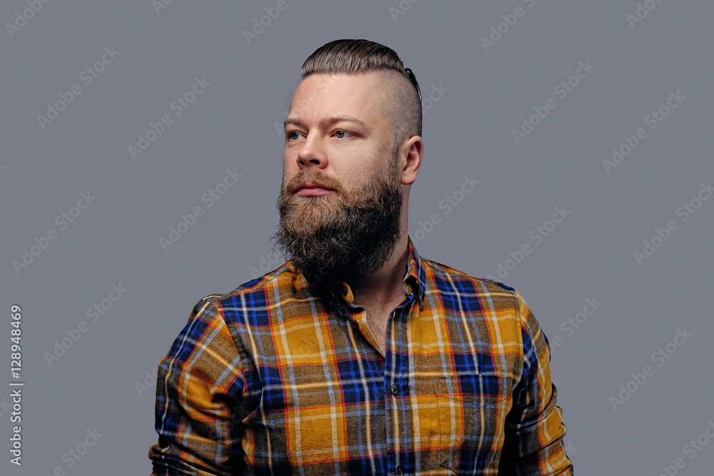 Portrait of a bearded male with punk hairstyle. Photos | Adobe Stock
