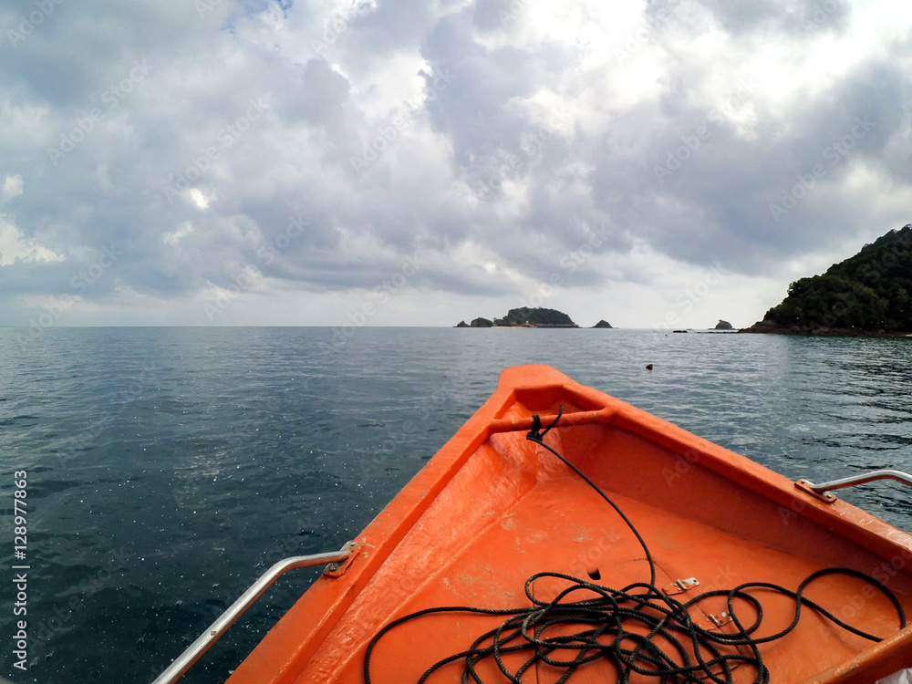 nose of fiber boat sailing to the island.cloudy sky background and ...