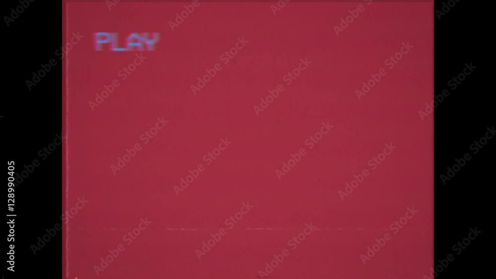 An old damaged VHS tape playing, red screen with PLAY text. A vintage ...