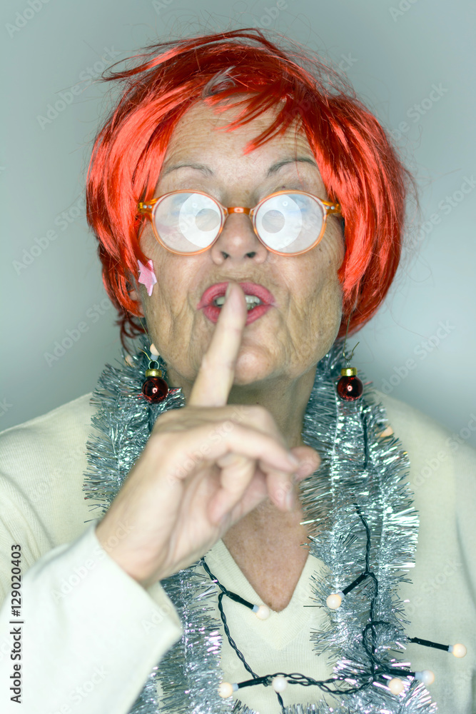 Closeup portrait, senior mature woman placing finger hand on lips, shhh ...