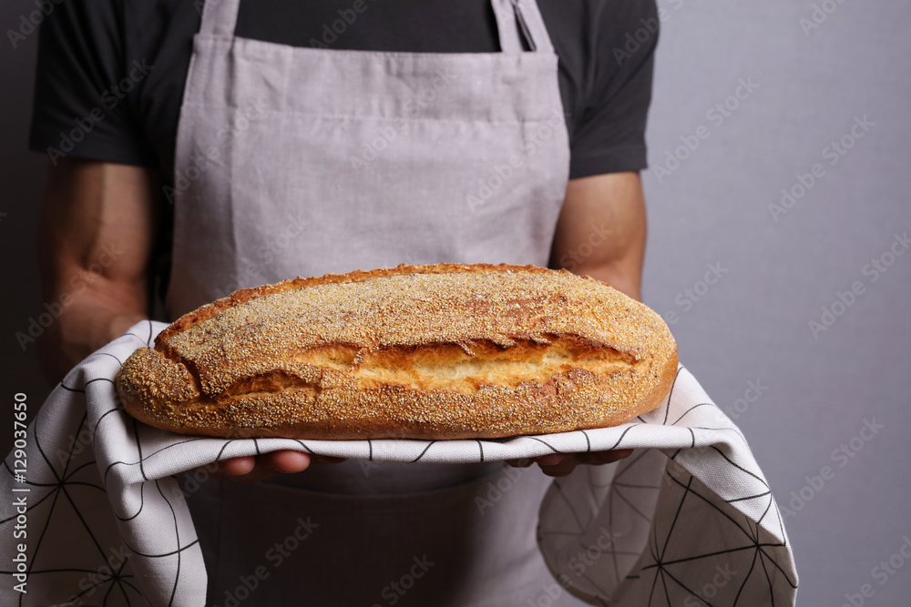 Man holding or giving bread as a welcome. Baker offer loaf of tasty ...