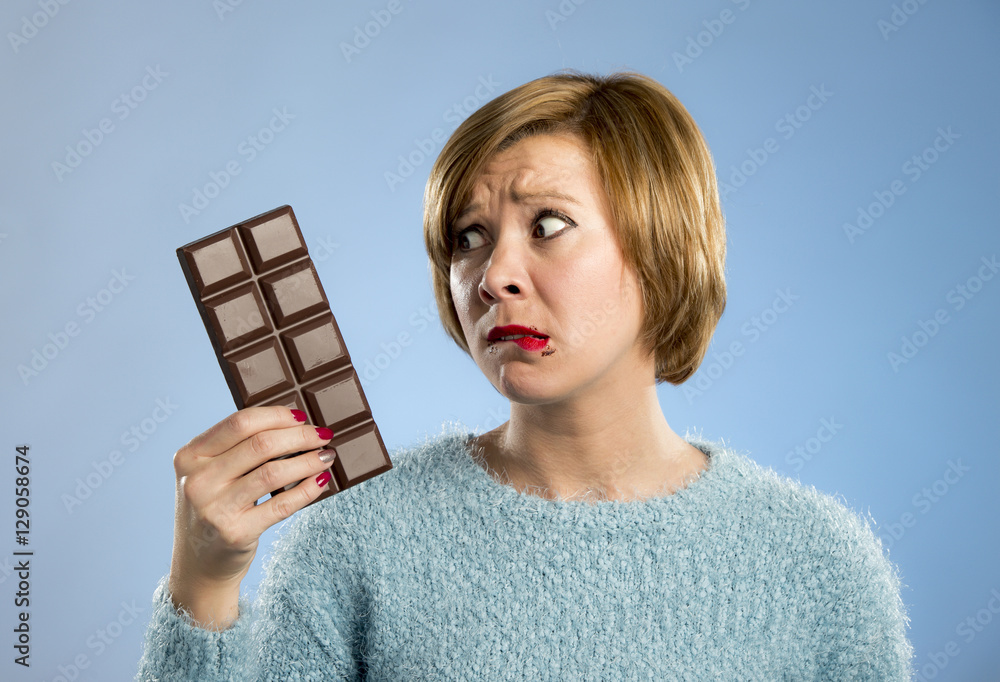 woman holding big chocolate bar with mouth stains and guilty face ...